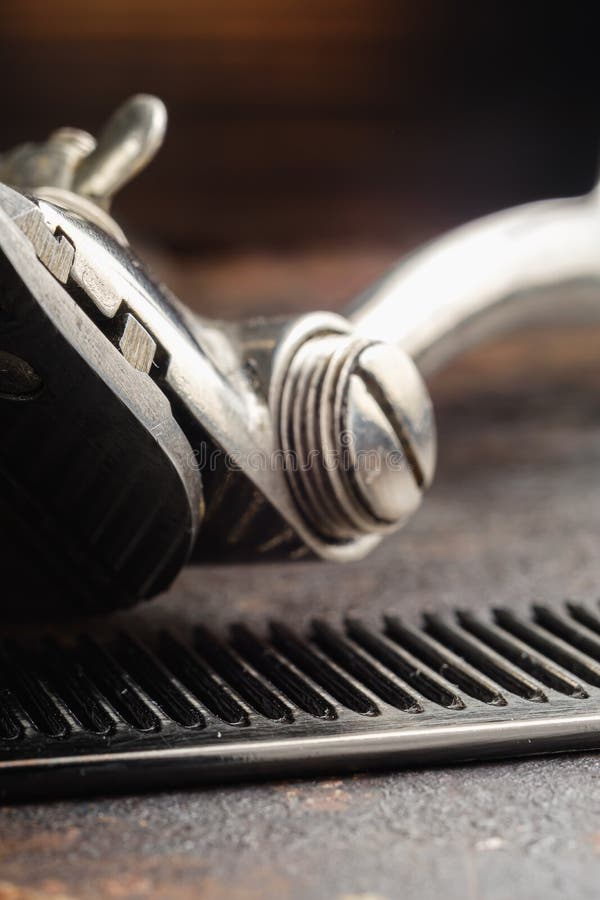 On a Rusty Surface Manual Clipper and Comb. Close Up. Rustic Stock ...