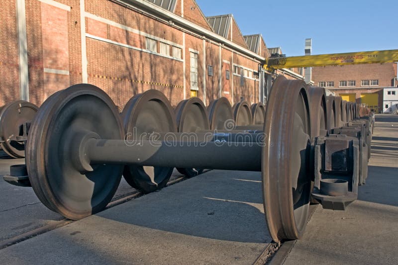 Train Wheel Sets in Front of an Industrial Building Editorial Stock ...