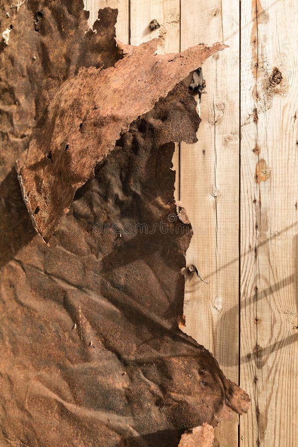 Rusty Twisted Sheet Metal on Wooden Plank Wall Stock Image - Image of ...