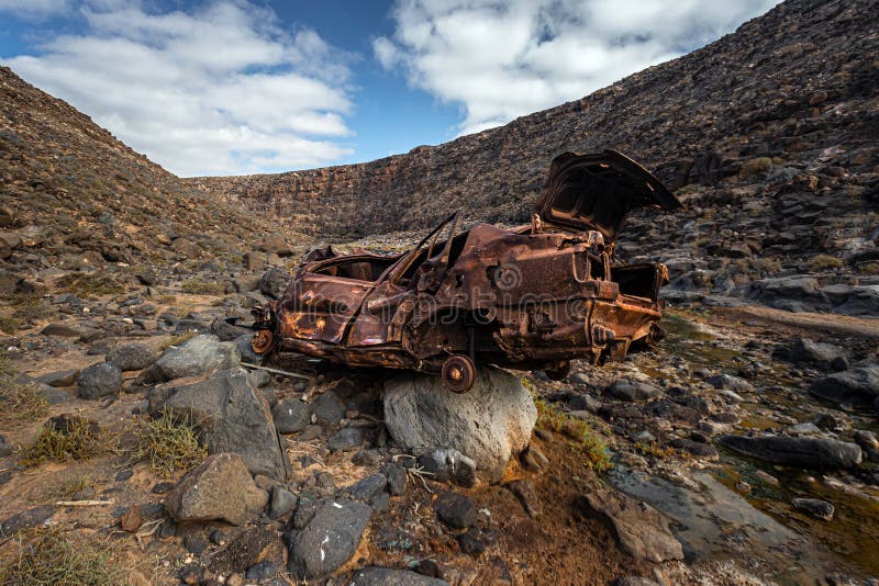 Rusty Vehicle Scrap at the Bottom of a Ravine Stock Photo - Image of ...