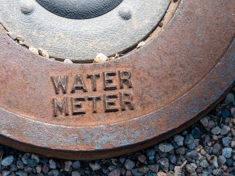 A rusty water meter plate stock photo. Image of relief - 297168660