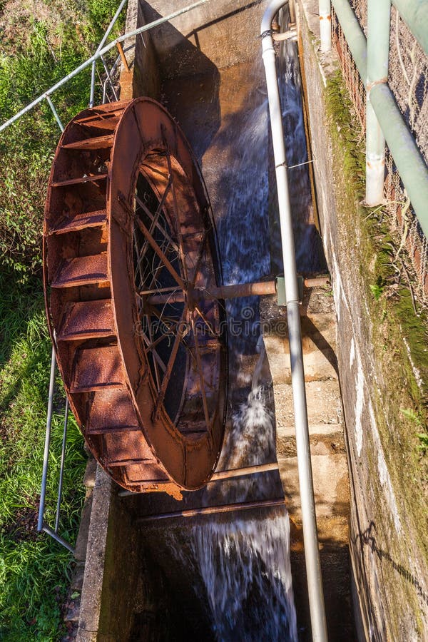 A Rusty Water Wheel with Flowing Water, Part of a Small Dam Stock Image ...