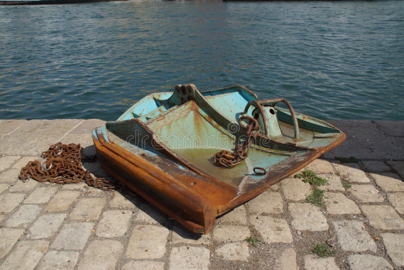 Rusty and Weathered Metallic Object of a Boat on the Ground in Front of ...