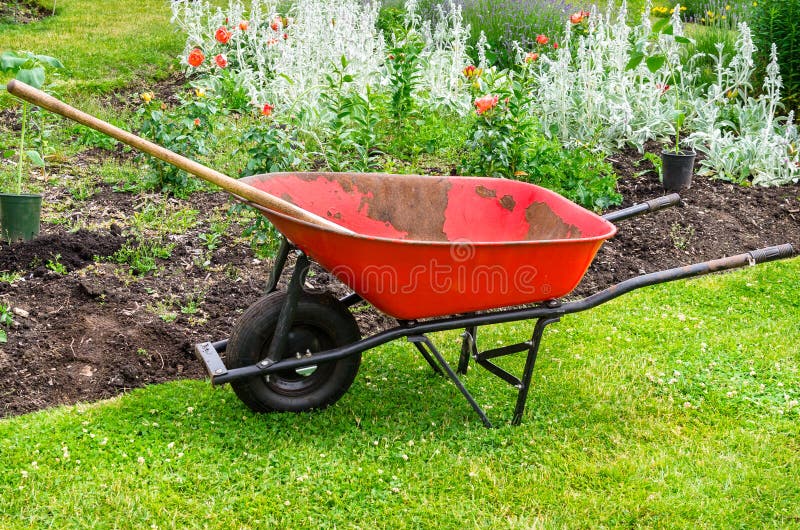 Gardening Tool in Front of a Flower Bed Stock Photo - Image of gardens ...