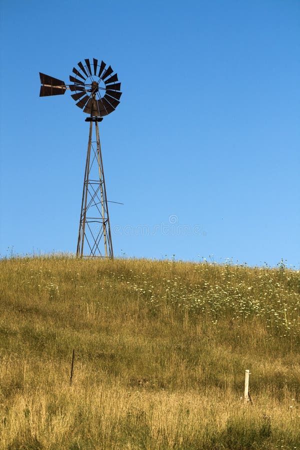 Rusty Windmill on Top of Hill in Pasture Stock Image - Image of ...