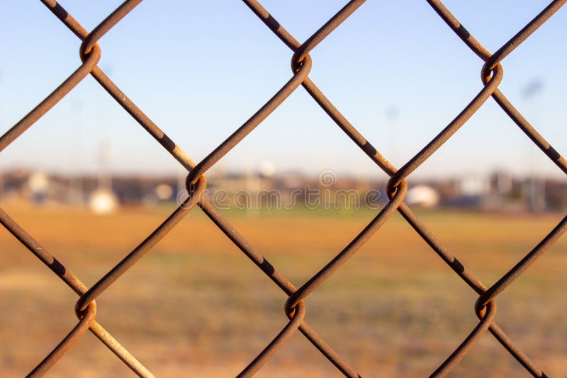 Rusty Wire Fence with Field and Buildings Stock Photo - Image of ...