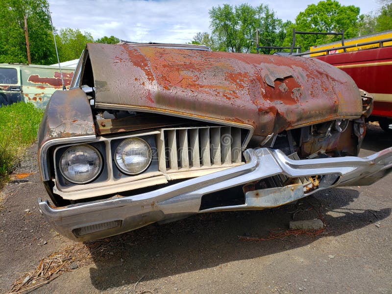 Rusty Wrecked Forgotten Car in a Junkyard Stock Photo - Image of ...