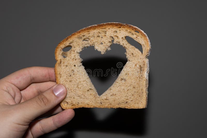 Rye Bread Bread Slice with Heart Shaped Hole on a Hand Stock Photo ...