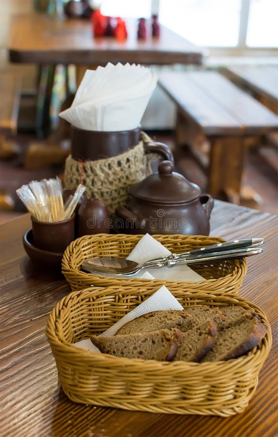 Rye Bread in Wicker Baskets on the Table and Cutlery in the Restaurant ...