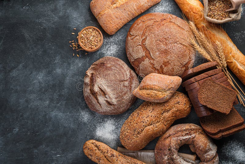 Rye and Wheat Bread of Different Types on a Dark Background with Flour ...