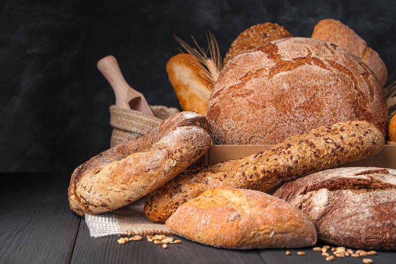Rye and Wheat Bread of Different Types on a Dark Background. Stock ...