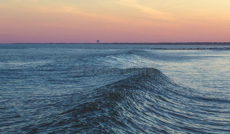 An Ocean Wave at Sunset stock photo. Image of twilight - 136749164