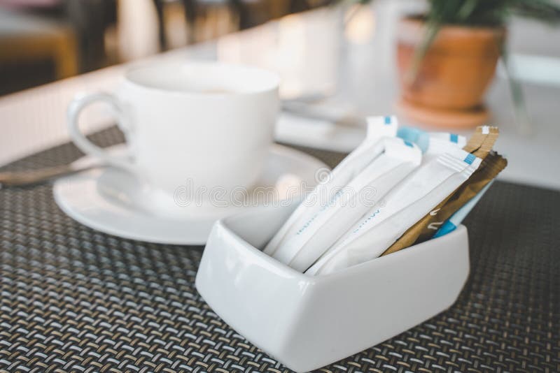 Sachet of Sugar in White Ceramic with Blurred Coffee Cup in Restaurant ...