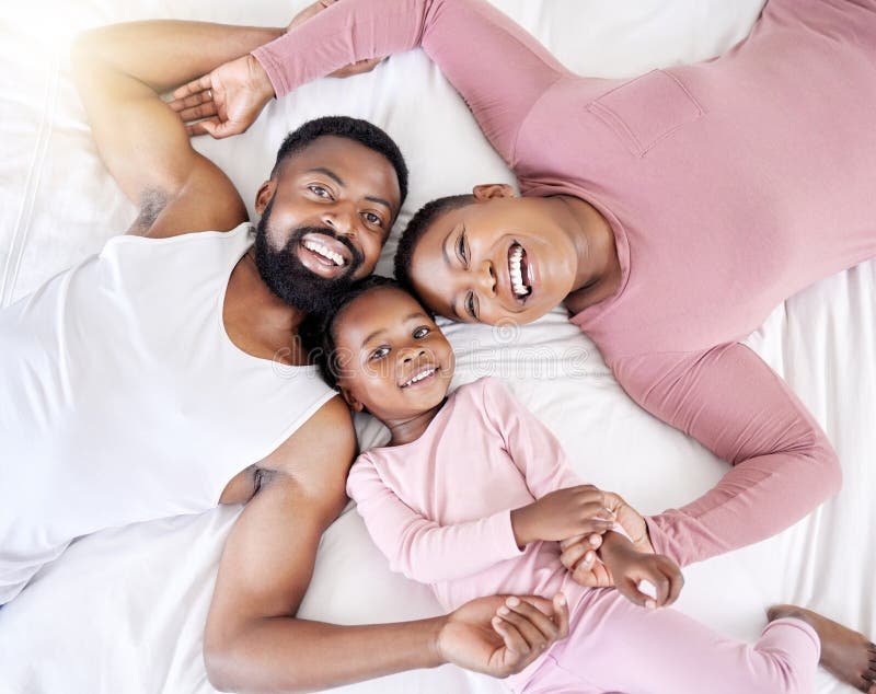 The Sacred Magic of Family. a Young Family Bonding in Bed Together ...