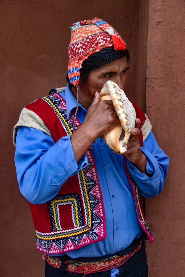 An Indigenous Quechua Man Blows on a Conch Shell. Cusco, Peru Editorial ...