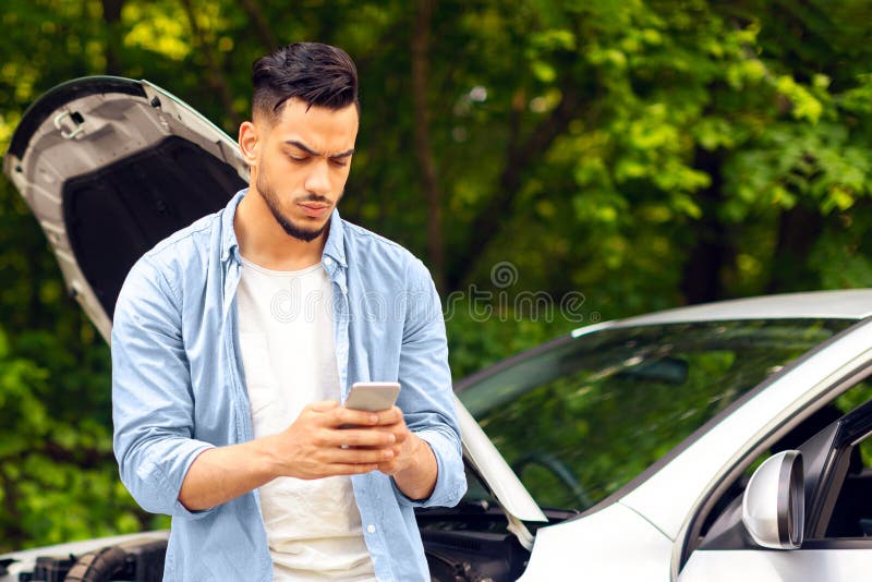 Sad Arab Man Looking for Auto Service, Using Smartphone Stock Image ...