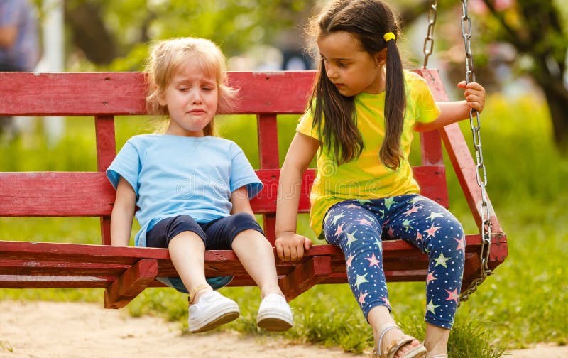 Sad Baby Girl Crying in the Park with the Swing Broken. Stock Image ...