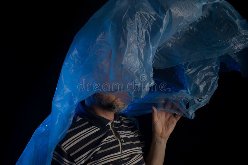 Sad Bald Mature Man Suffocating with a Plastic Bag Flying Over His Head ...