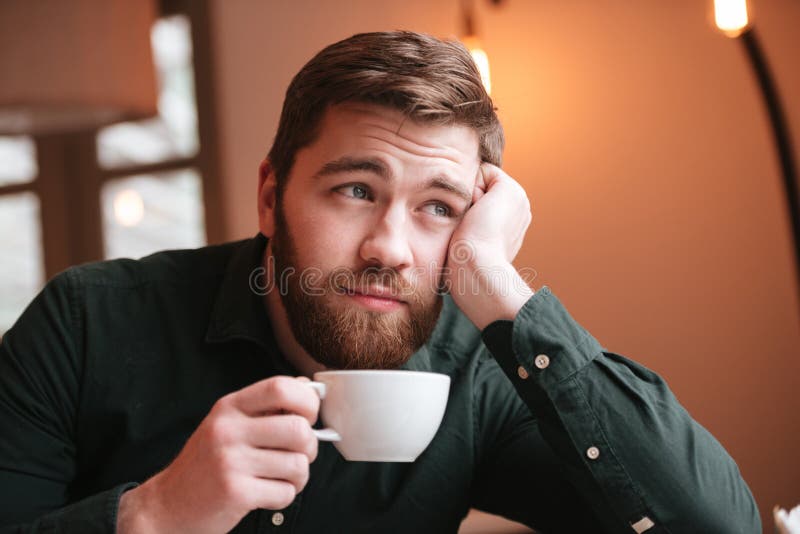Sad Bearded Young Man Drinking Coffee. Stock Photo - Image of working ...