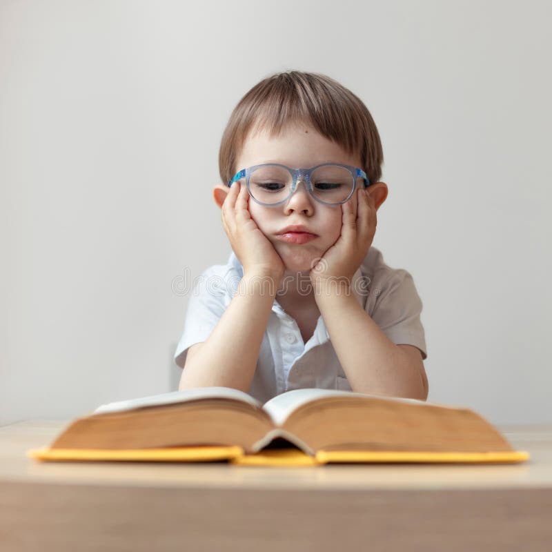 .sad Boy is Bored Looking at the Open Book in Front of Him, Learning To ...