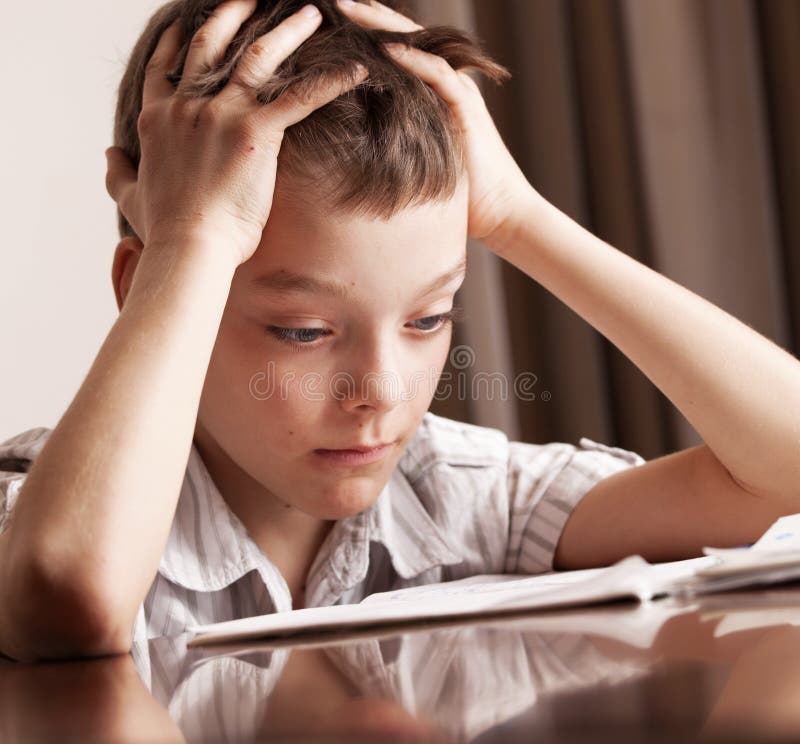 Sad boy doing homework stock image. Image of book, homework - 153195447