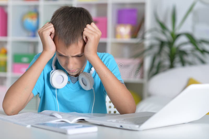 Sad Boy in Headphones Using Laptop in Room Stock Photo - Image of ...