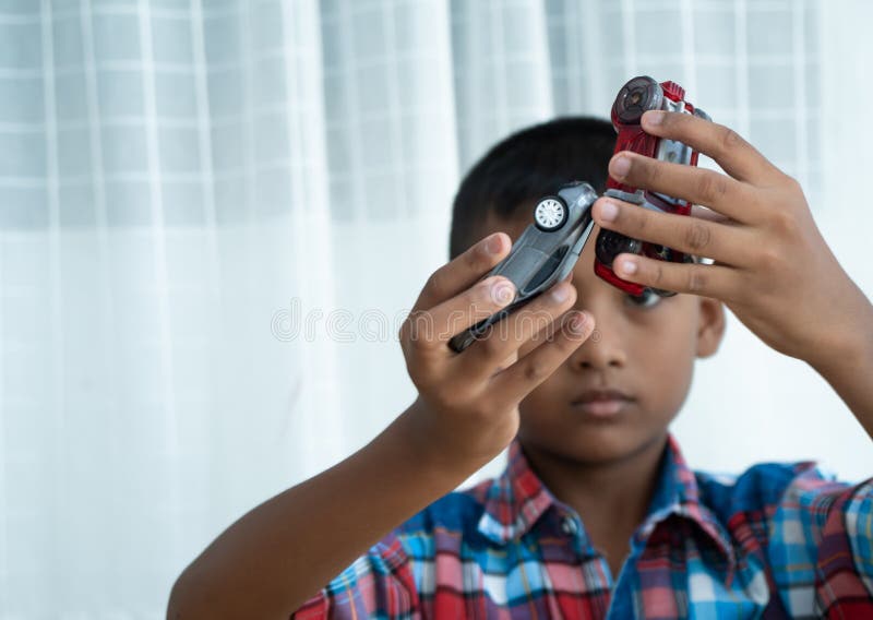 Sad Little Boy Lying on the Table and Play Toy Car Stock Photo - Image ...