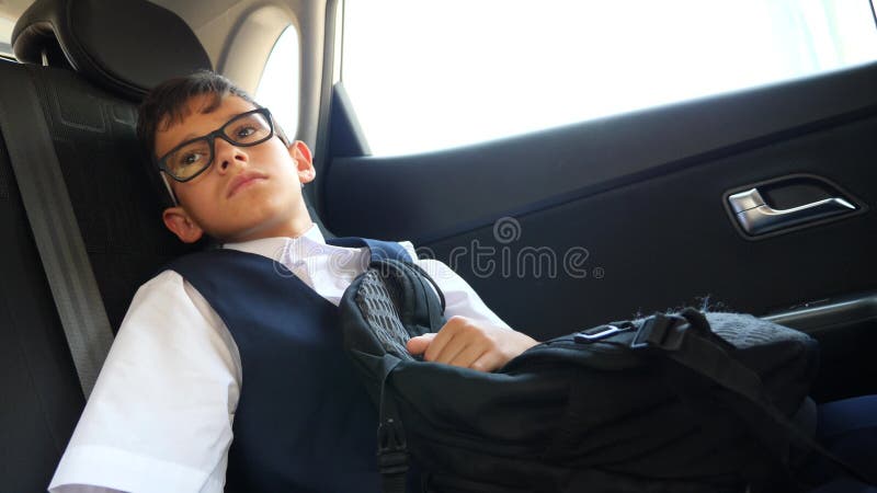 The Sad Boy is Riding in the Car in School Uniform. 4k, Slow-motion ...