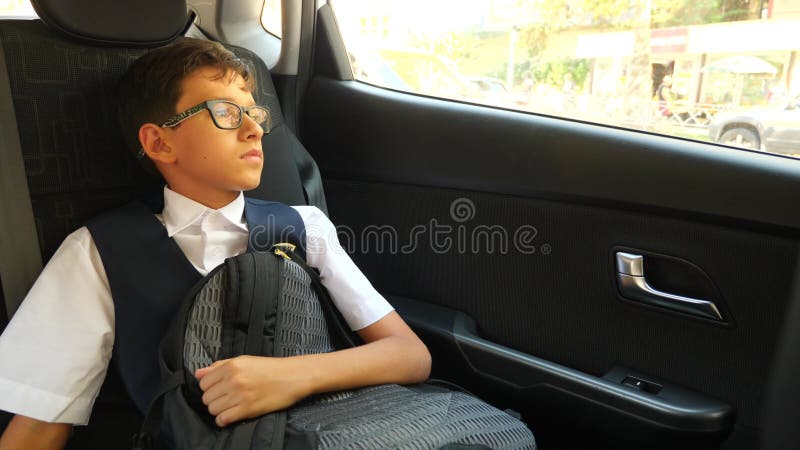 The Sad Boy is Riding in the Car in School Uniform. 4k, Slow-motion ...