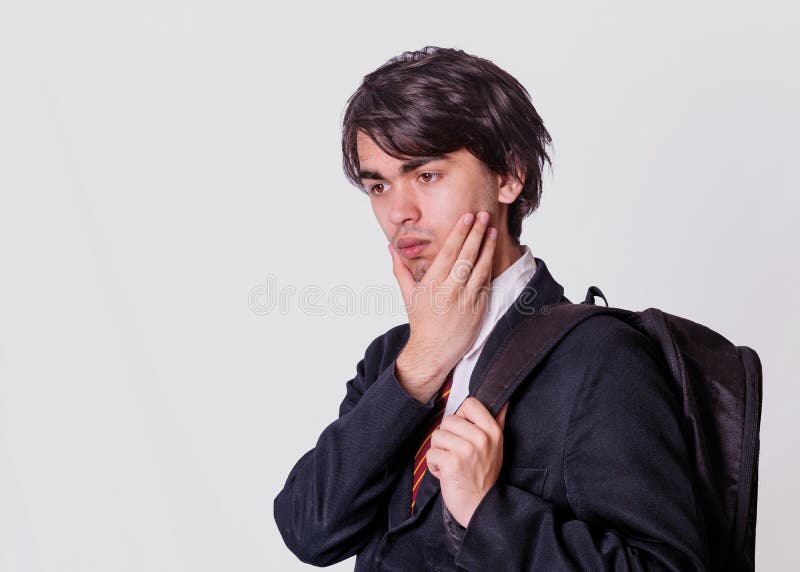 Sad Boy in a School Suit and with a Backpack Going Back To School Stock ...