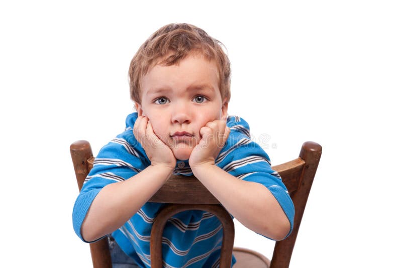 Sad boy sitting on chair stock photo. Image of human - 19535022