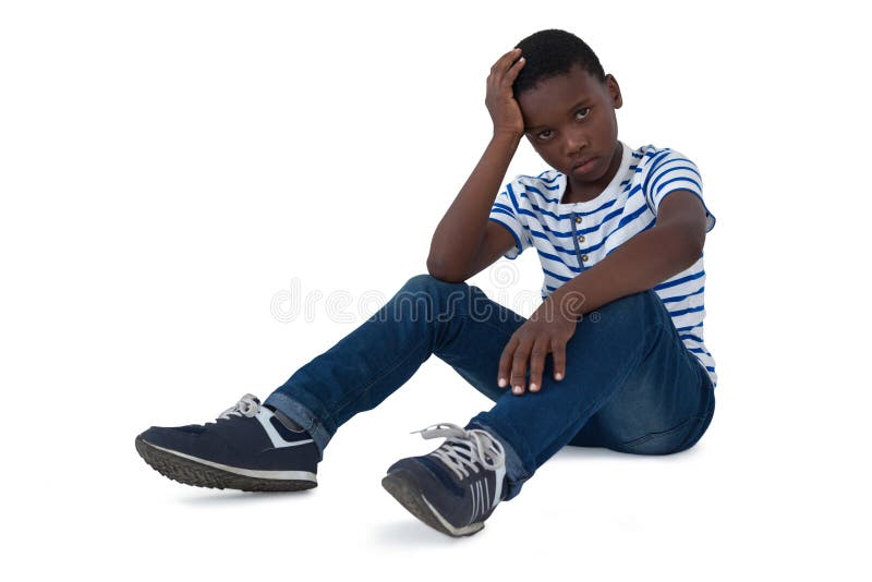 Sad Boy Sitting With Hand On Head Against White Background Stock Photo ...