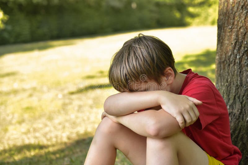 Sad Boy Sitting Under a Tree in Nature Stock Photo - Image of mental ...