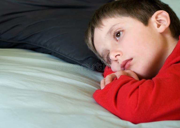 Sad boy thinking stock photo. Image of laying, unhappy - 19065070
