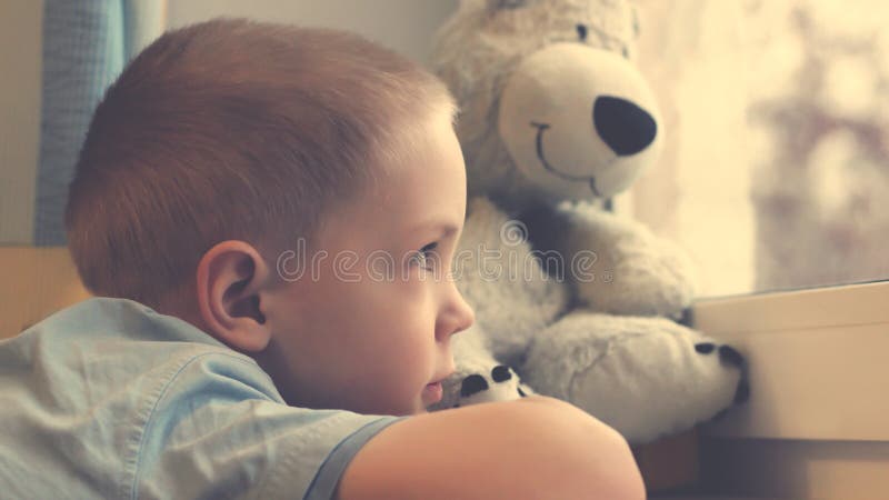 Sad Boy at the Window and Bear Toy, Loneliness and Depression Stock ...