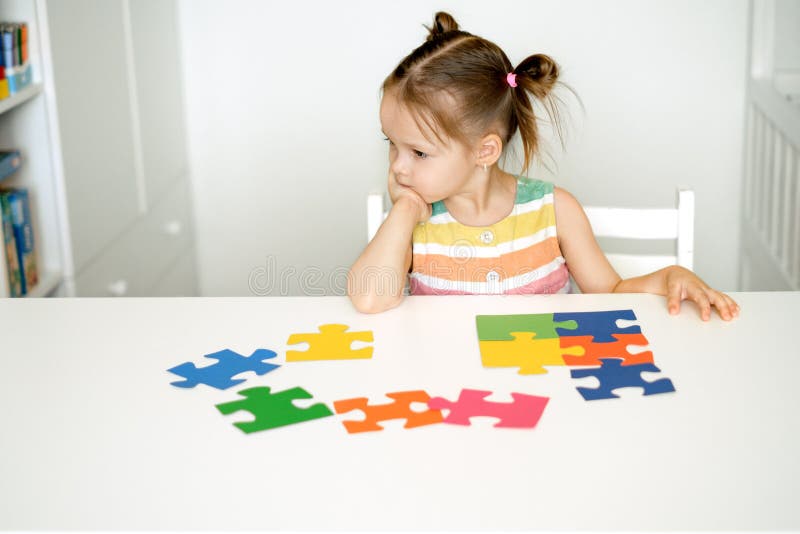 Sad, Brooding Girl with Autism is Sitting at Desk Solving Puzzle Stock ... Sad, Brooding Girl with Autism is Sitting at Desk Solving Puzzle Stock ...