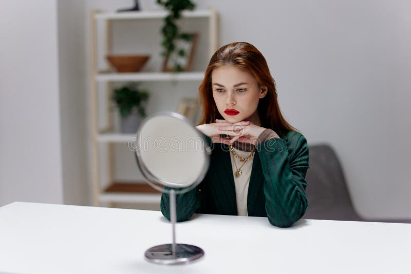 A Sad, Brooding, Tired Young Red-haired Woman at the Table is Thinking ...