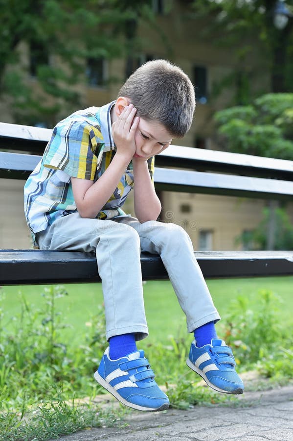 Sad child boy sitting stock image. Image of serious - 169882203