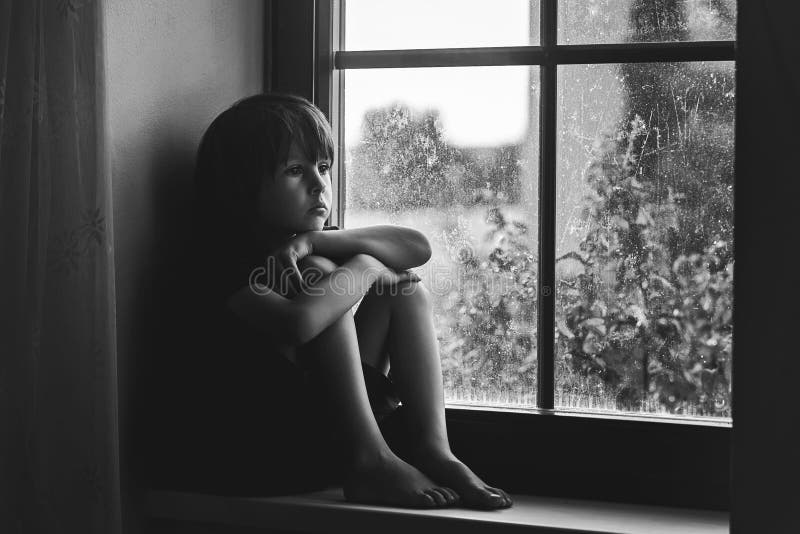 Sad Child Sitting on a Window on a Rainy Day Stock Photo - Image of ...