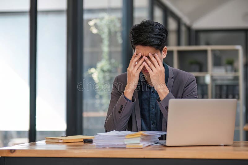 Focused Serious Professional Using Laptop in Office Lobby. Young Asian ...