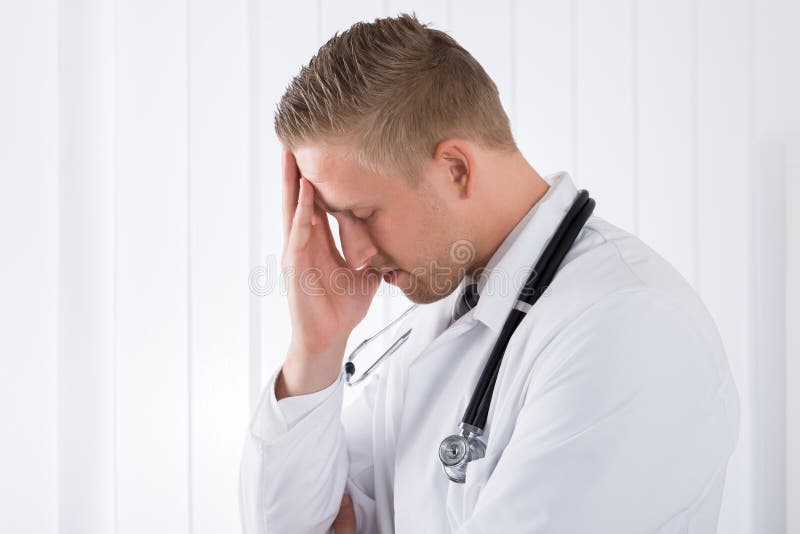 Sad Doctor Standing in Clinic Stock Photo - Image of hospital, pressure ...