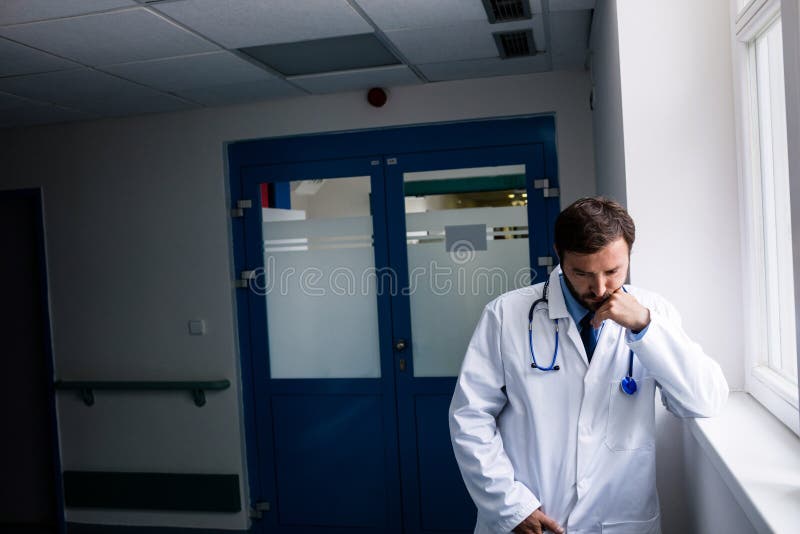 Sad Doctor Standing in Corridor Stock Image - Image of profession ...