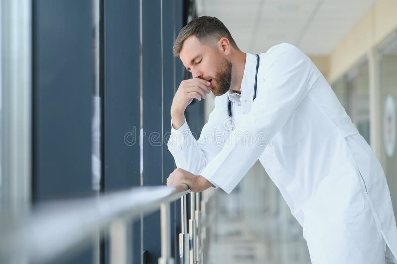Sad Doctor Standing in Hospital Corridor Stock Image - Image of ...