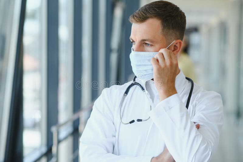 Sad Doctor Standing in Hospital Corridor Stock Image - Image of clinic ...
