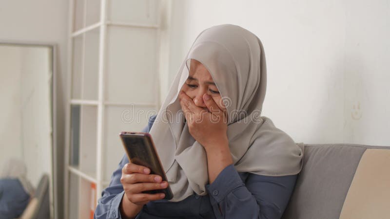 Sad Emotional Asian Muslim Woman Crying And Sends A Message On Mobile