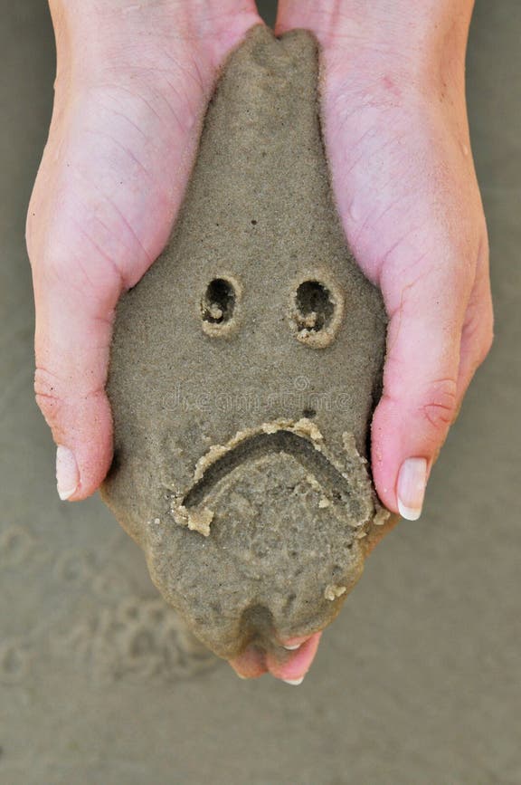 Sad face on sand stock photo. Image of emotion, hand - 11033638