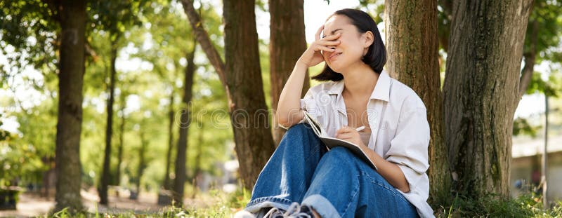Sad Girl Crying while Writing in Her Diary, Sitting Alone Under Tree in ...