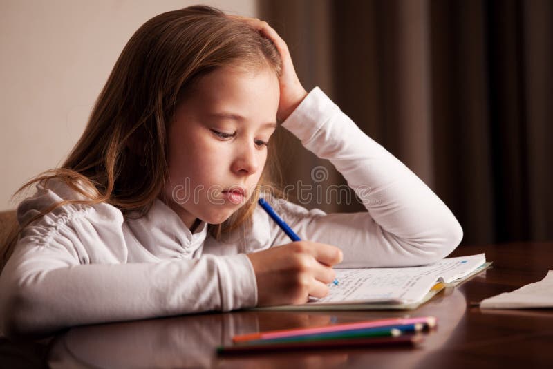 Sad girl doing homework stock image. Image of school - 34383011