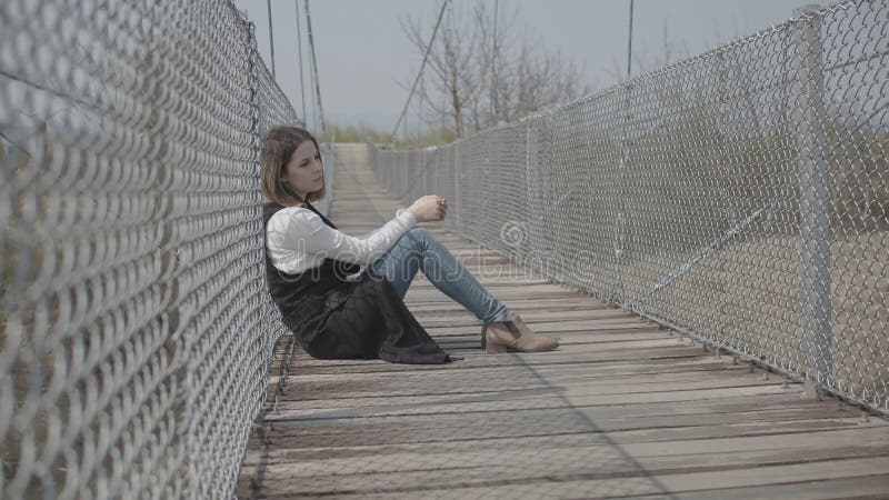Sad Girl Sitting on a Bridge Stock Footage - Video of unhappy ...