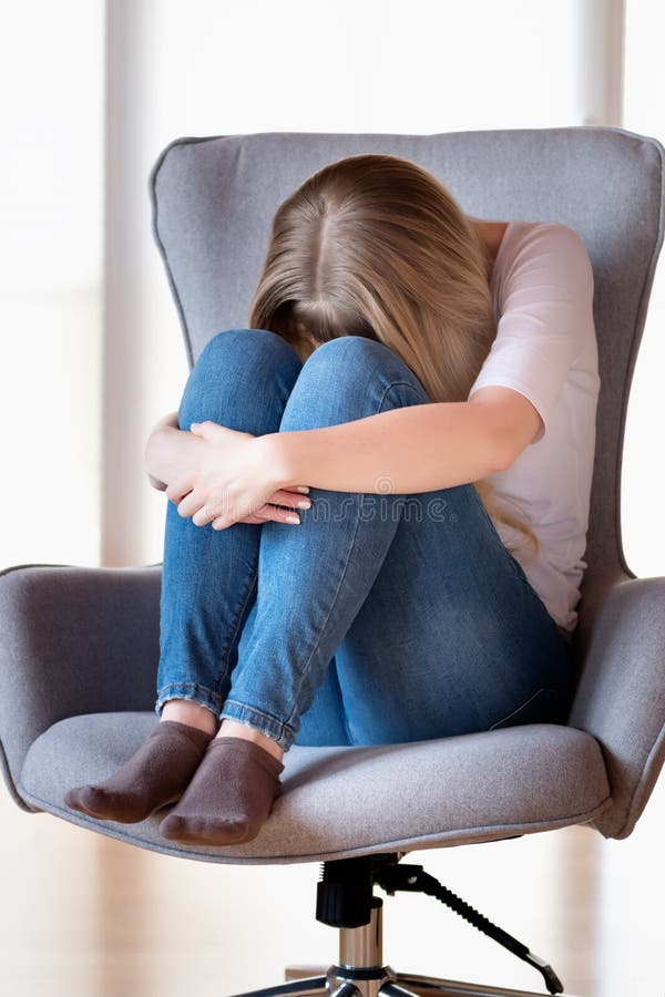Sad girl sitting on chair stock image. Image of stress - 132742545